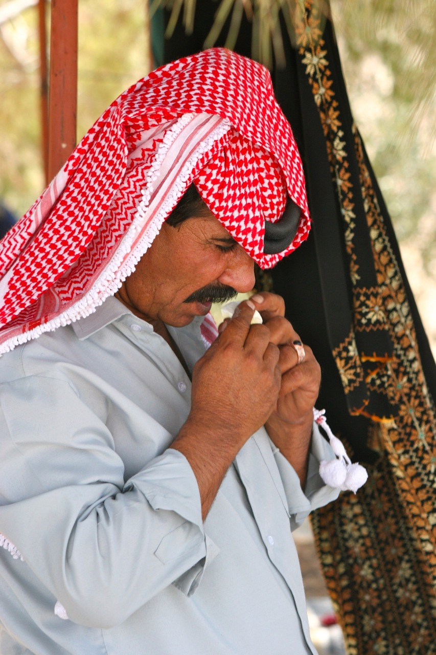 a Bedouin man tasting jameed – Jordan tour – Engaging Cultures Travel